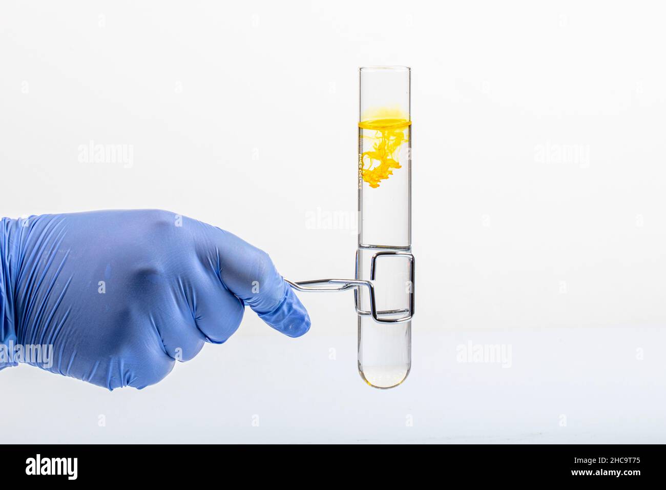 Test tube with yellow reagent and pipette close-up. Colored liquid in ...