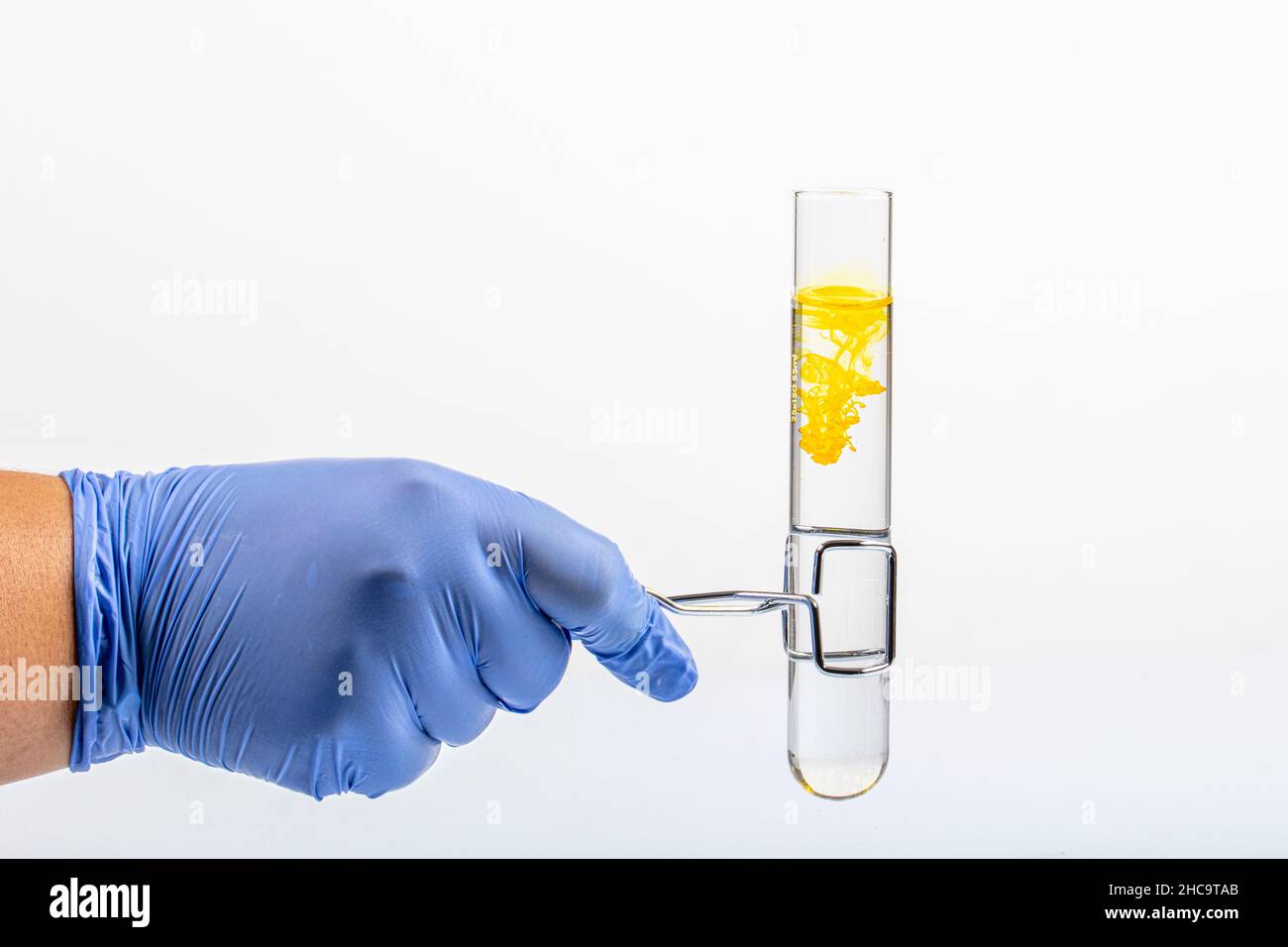 Test tube with yellow reagent and pipette close-up. Colored liquid in ...