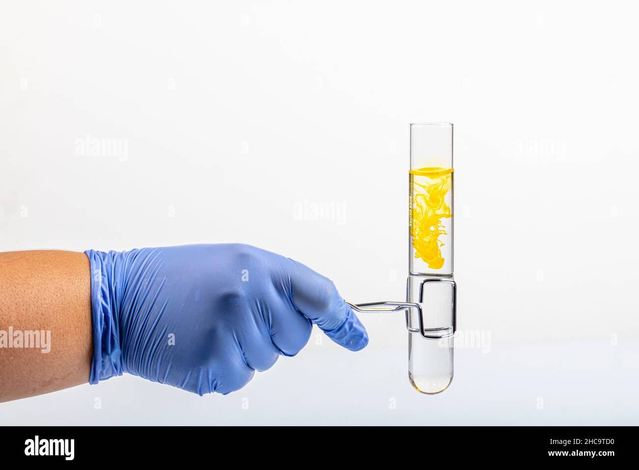 Test tube with yellow reagent and pipette close-up. Colored liquid in ...