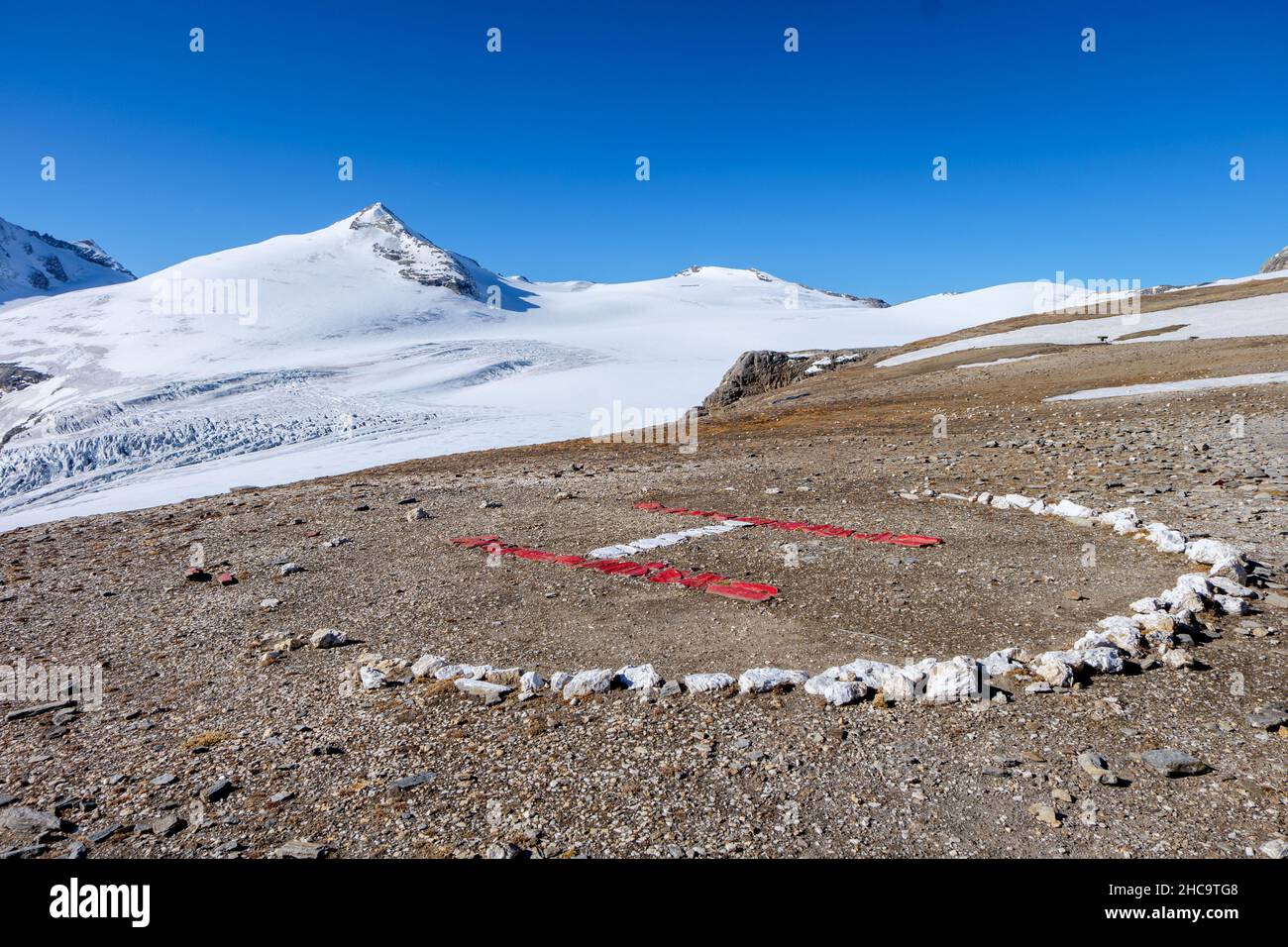 Mountain heliport near Oberwalderhütte, made of stones, with glacier ...