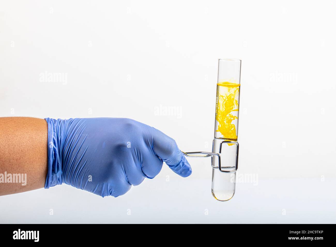 Test tube with yellow reagent and pipette close-up. Colored liquid in ...