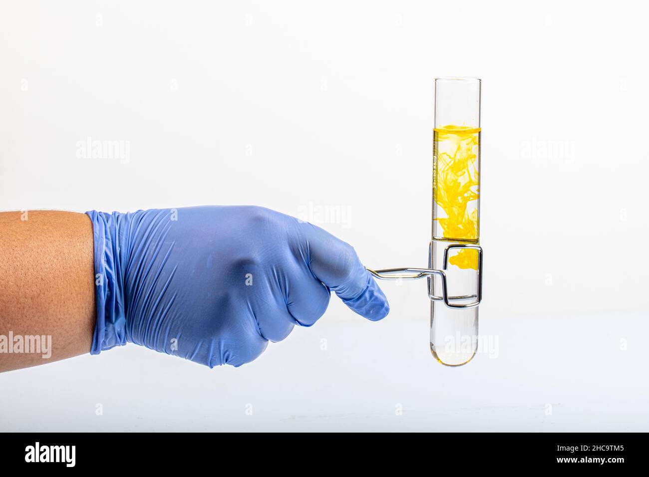 Test tube with yellow reagent and pipette close-up. Colored liquid in ...