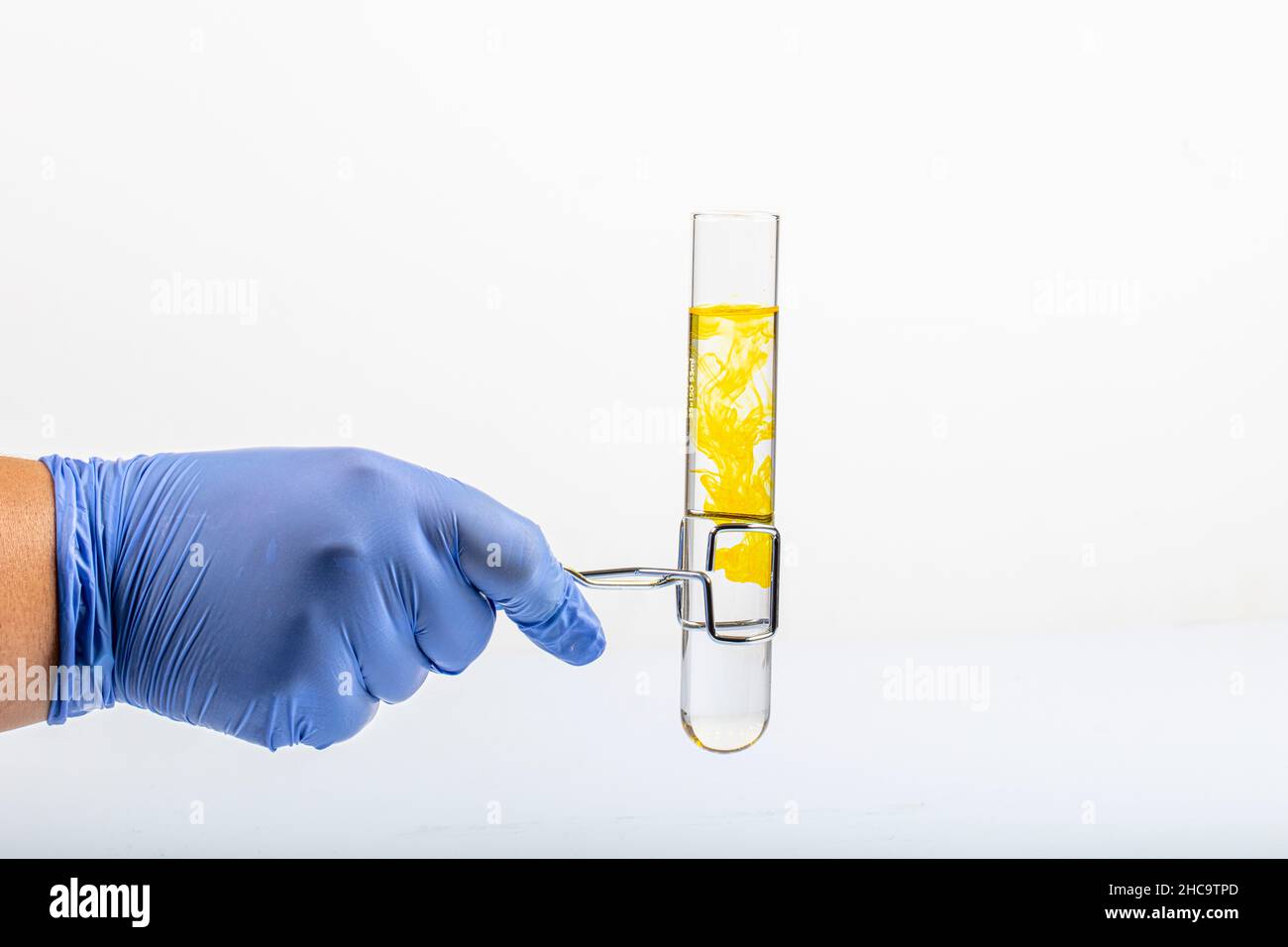 Test tube with yellow reagent and pipette close-up. Colored liquid in ...