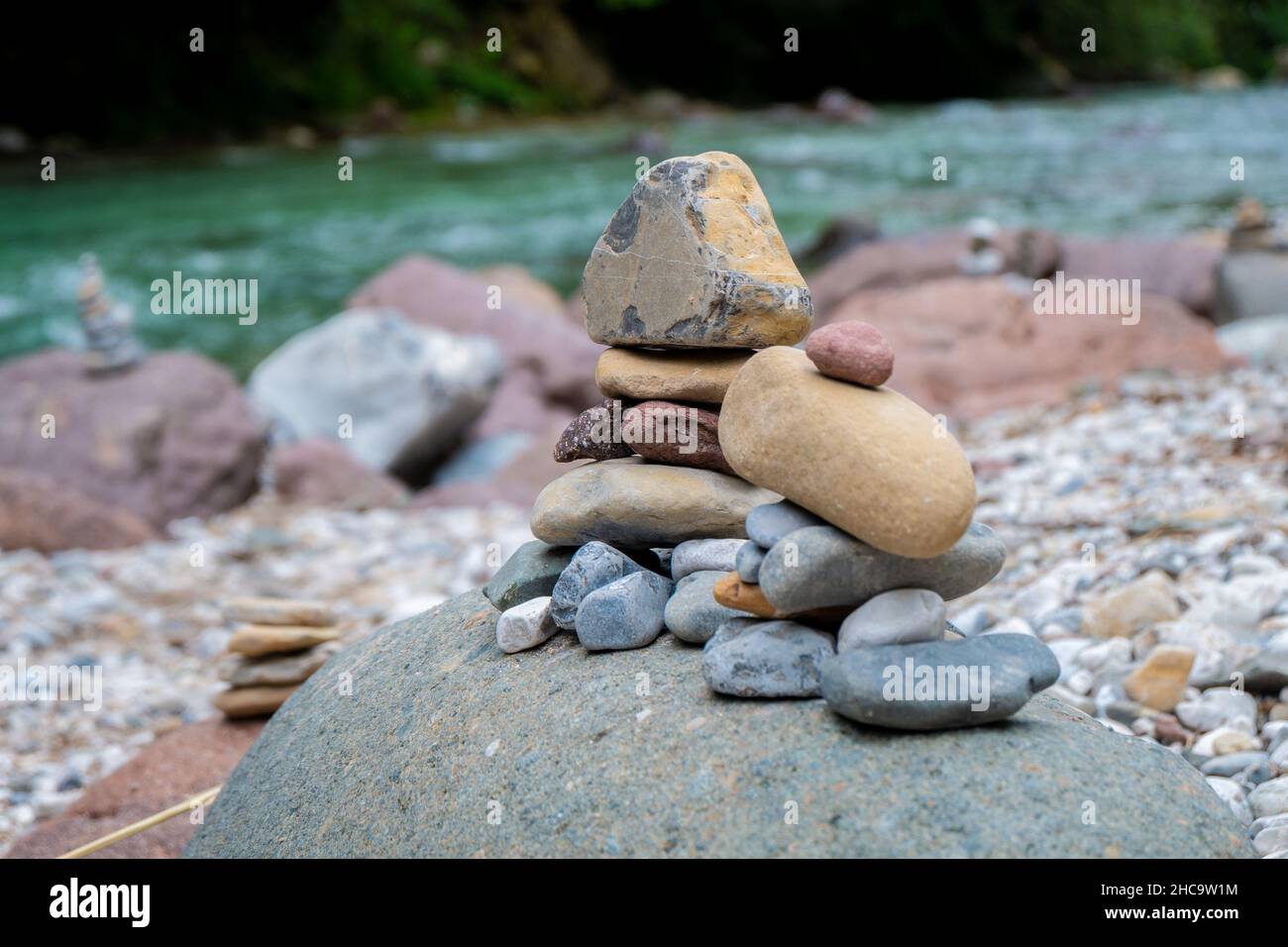 A colorful cairn (pile of rocks) near the Slizza stream in Orrido dello ...