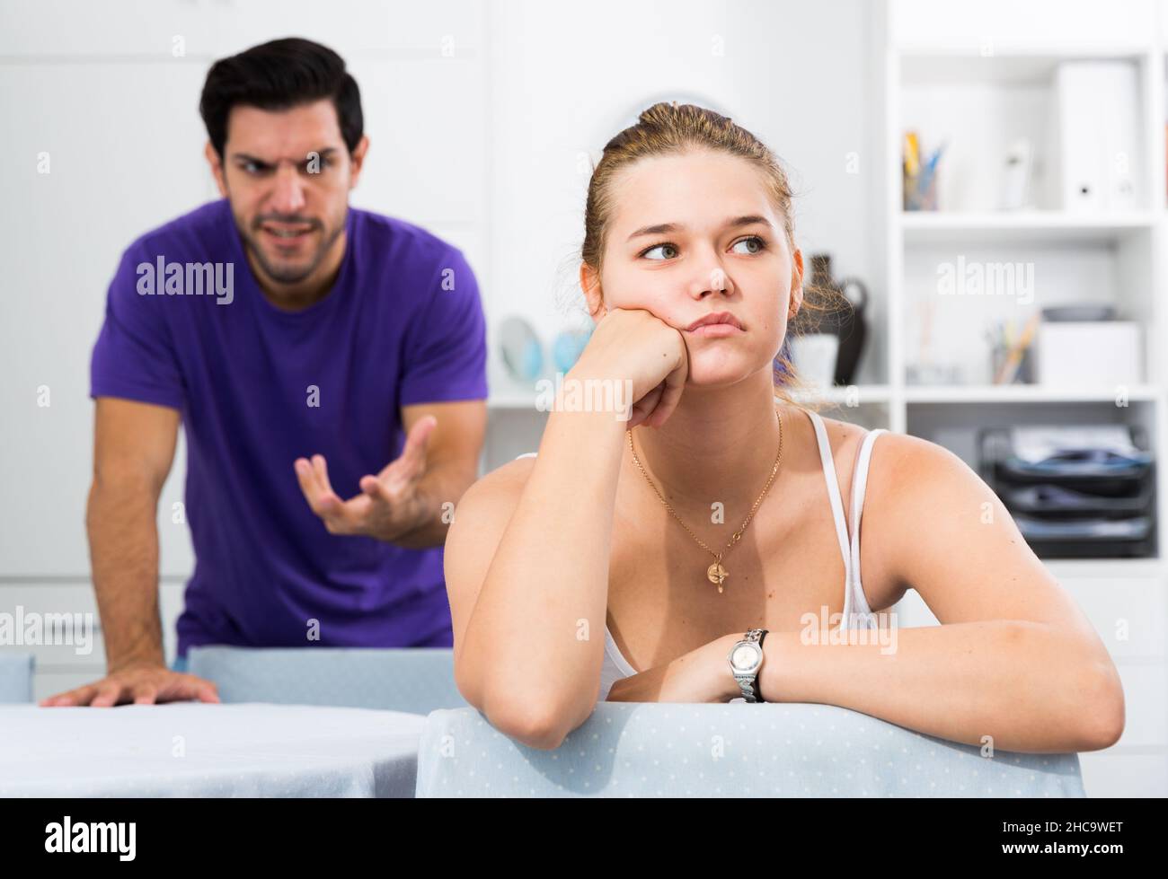 Frustrated girl at table with angry boyfriend Stock Photo - Alamy