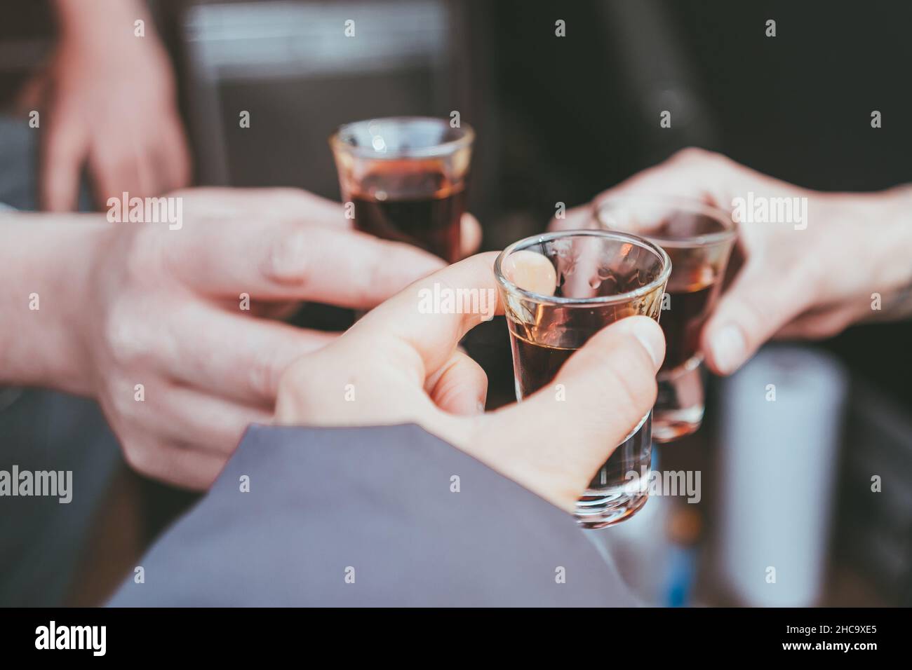 Three friends toast to health and drink liquor Stock Photo - Alamy
