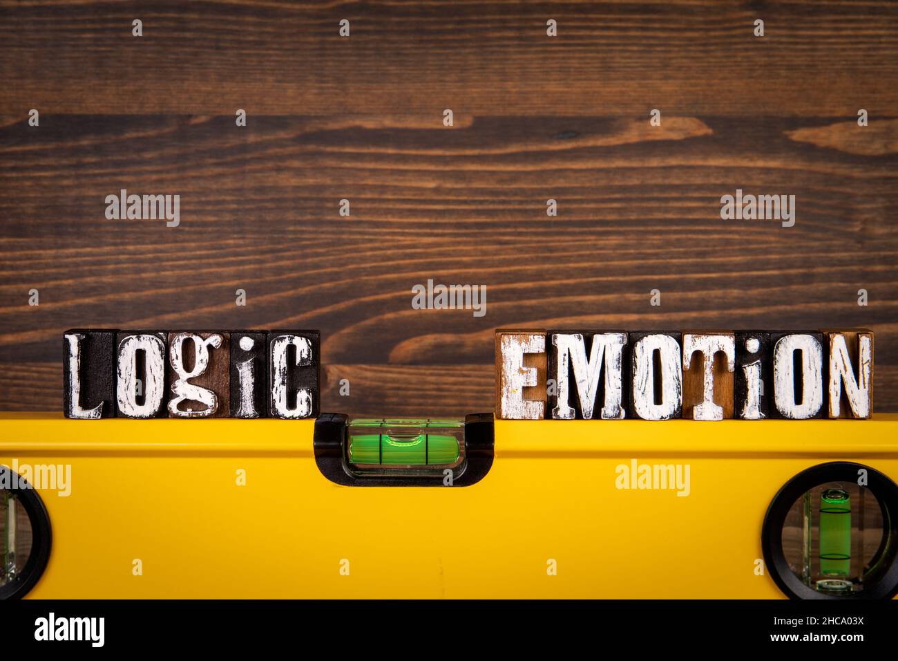 Logic and Emotion balance concept. Alphabet blocks on a wooden ...