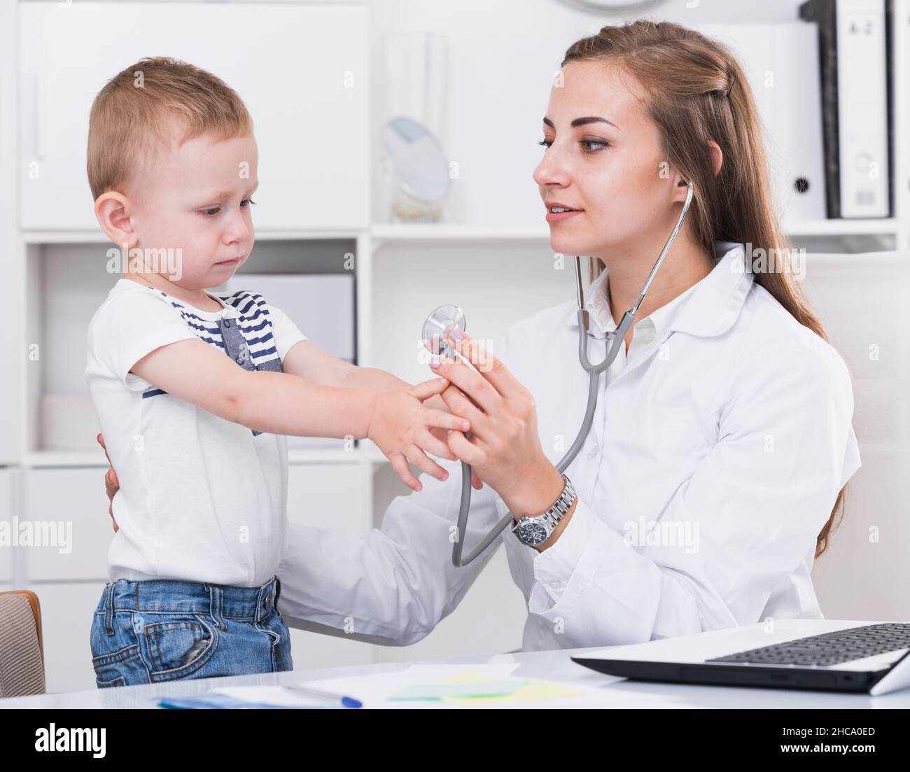 Female doctor is listening child with a stethoscope Stock Photo - Alamy