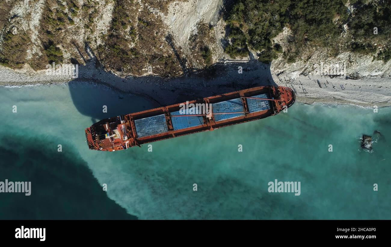 Aerial top view of an empty, red barge moored near the beautiful blue ...