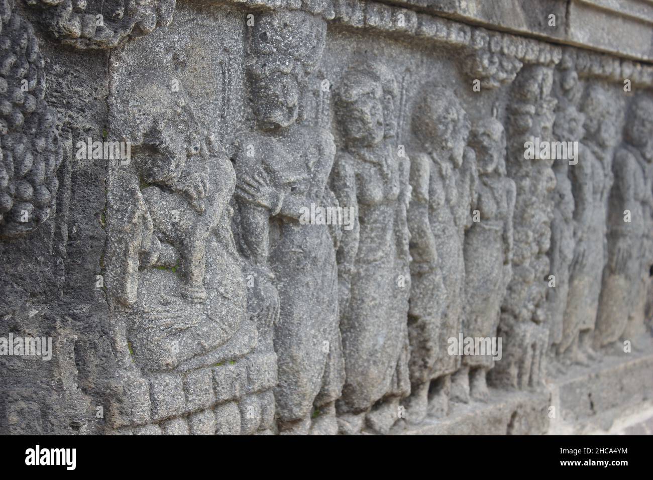 reliefs of traditional statues and buildings at the Penataran Temple in ...