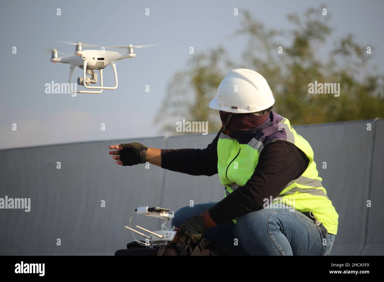 drone operator flying his drone to record the atmosphere at work Stock ...
