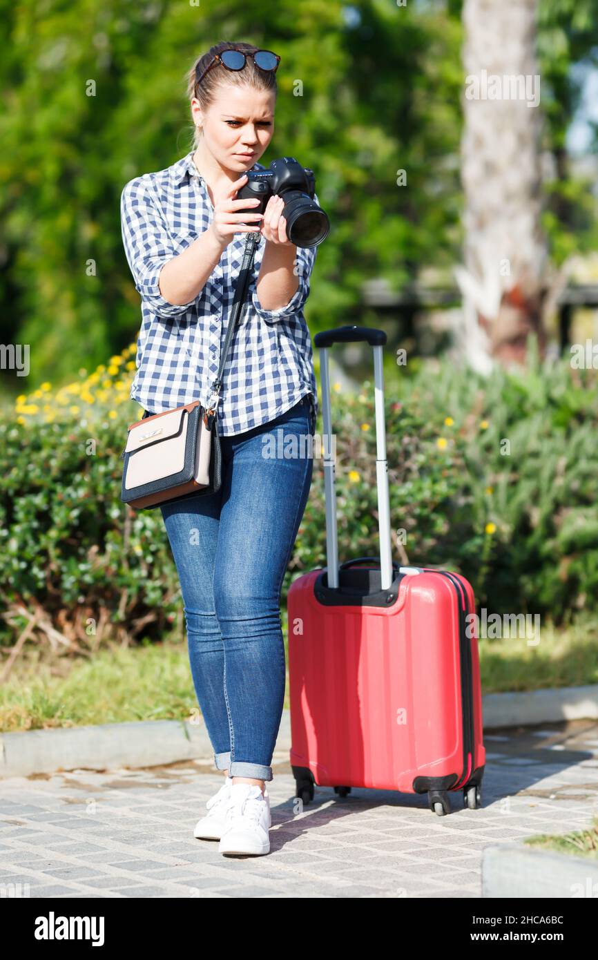 Adult woman traveler making photo of sights Stock Photo - Alamy