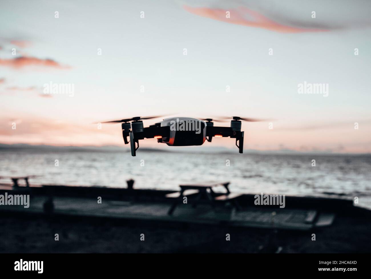 Flying drone against the sea and evening sky Stock Photo - Alamy