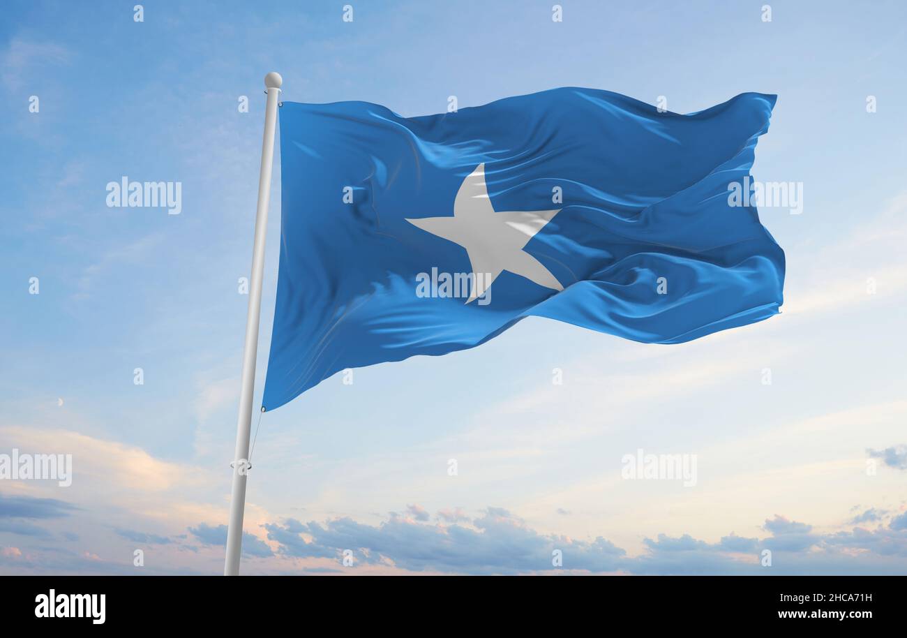 official flag of Somalia at cloudy sky background on sunset, panoramic ...