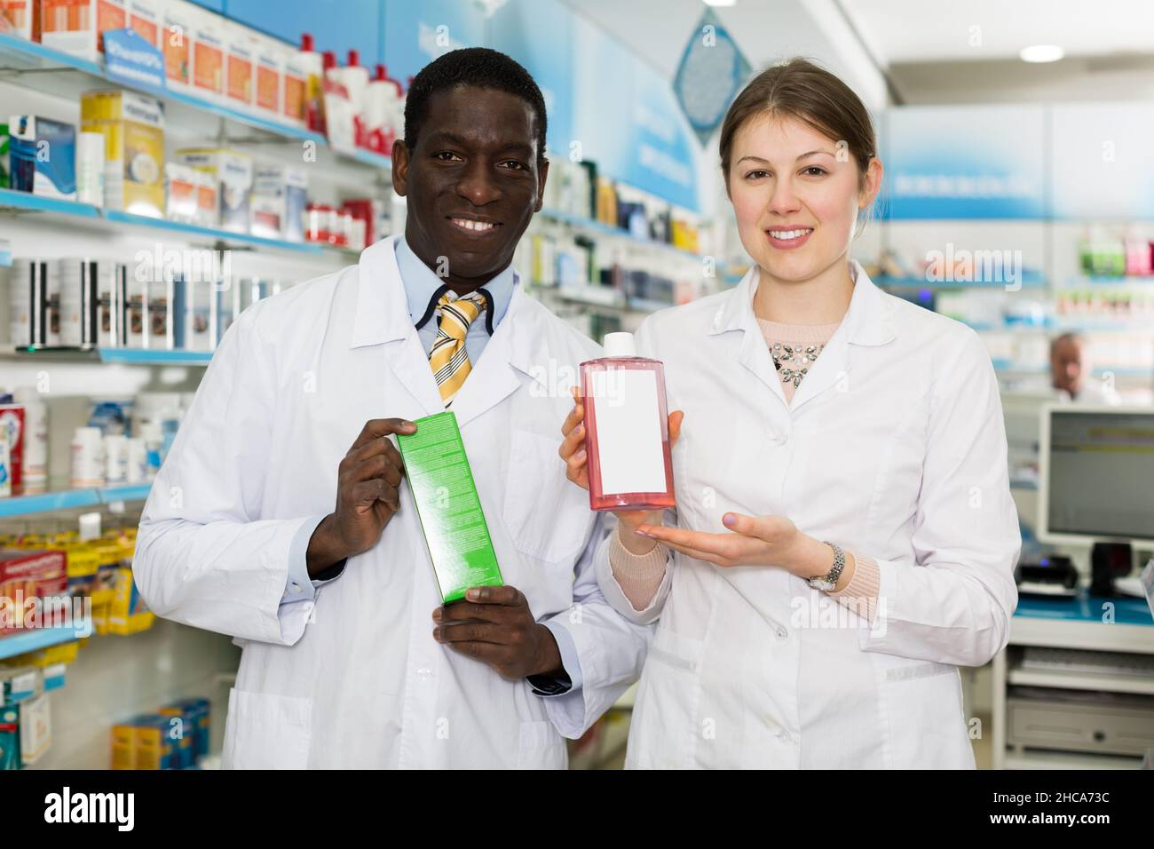 two pharmacists offering medication Stock Photo - Alamy