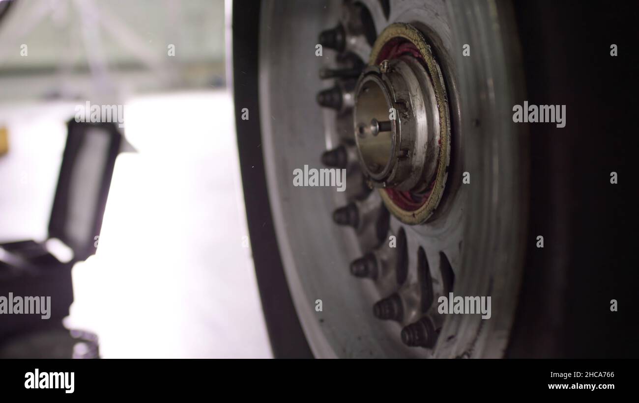 Airport worker checking chassis. Engine and chassis of the passenger ...