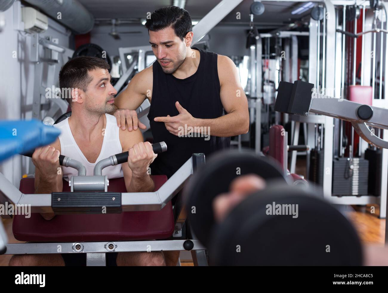 Guy with trainer in gym Stock Photo - Alamy