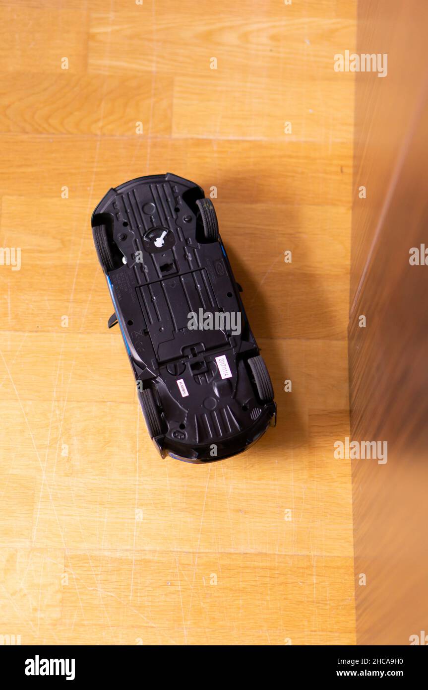Plastic toy model car laying upside down on a wooden floor Stock Photo ...