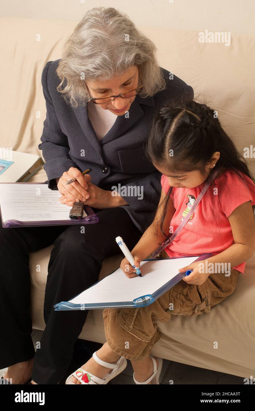 Researcher on home visit to three year old girl interacting with her ...