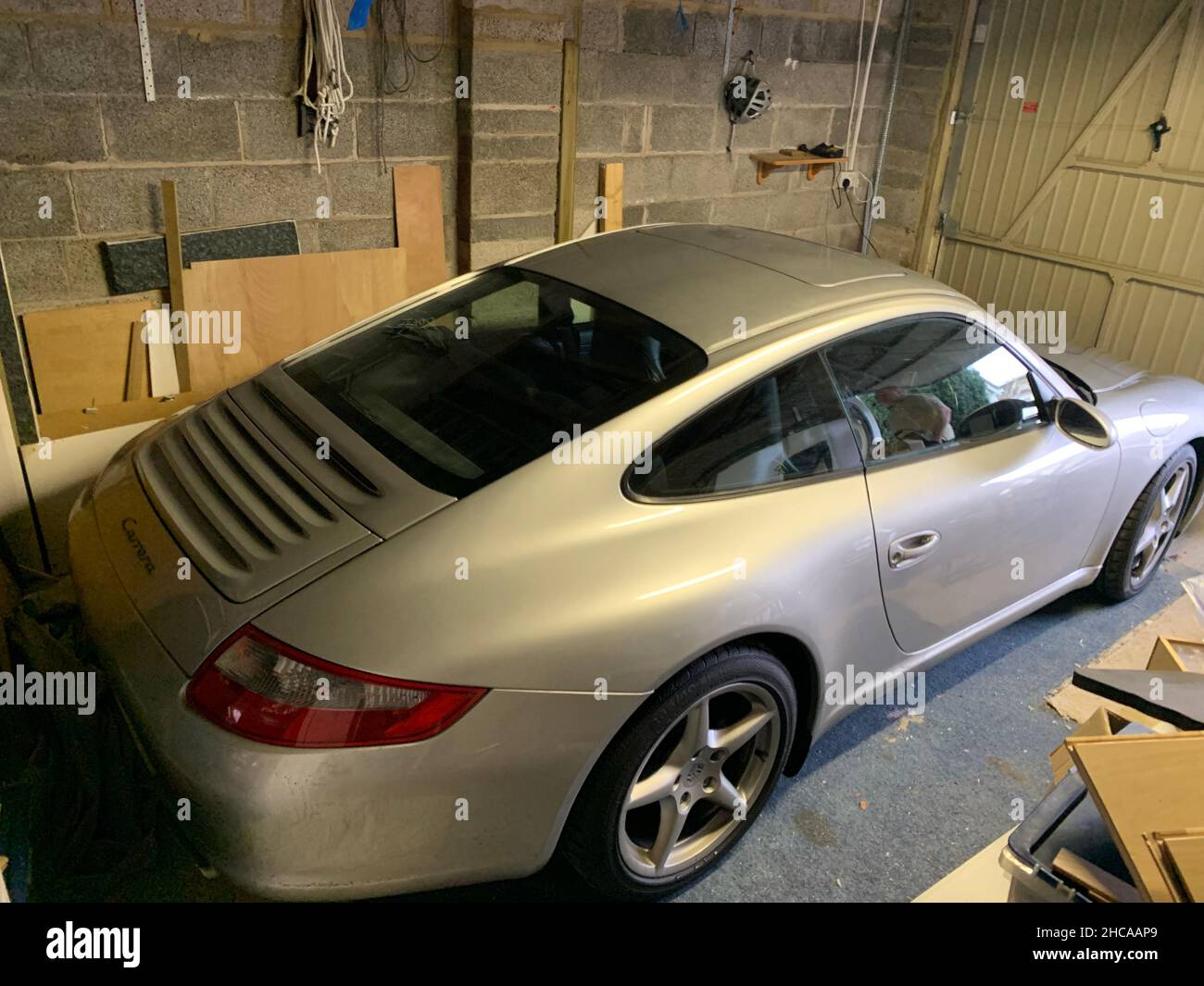 Porche 911 in garage fast silver German engineering shape body looks ...