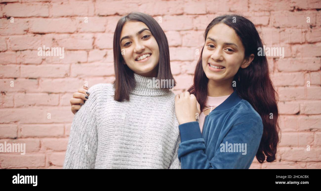 Closeup of two Indian females smiling, one of them holding other's ...