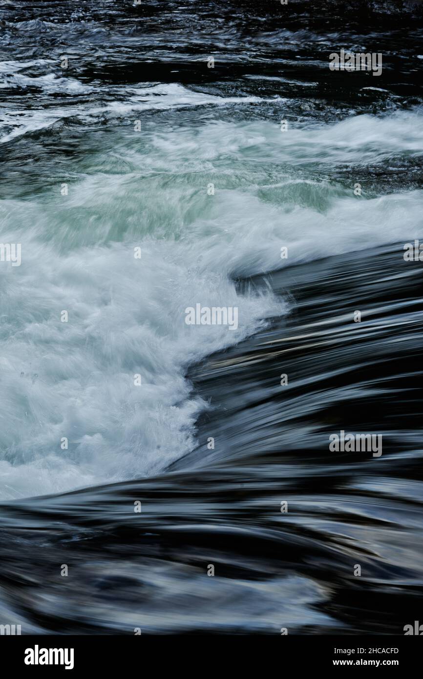 Vertical closeup shot of water flowing into the river Stock Photo - Alamy