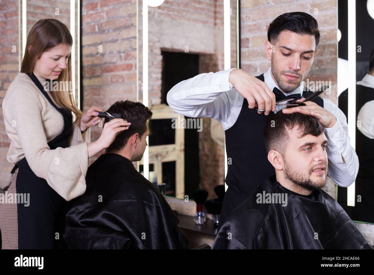 Barber making haircut client indoors hi-res stock photography and ...