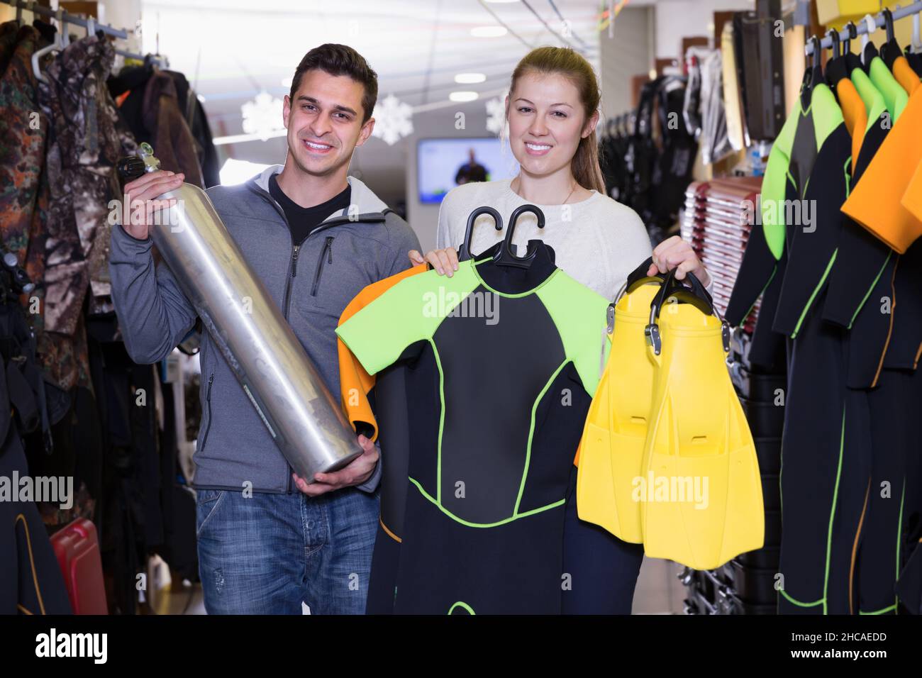 Male and girl standing with diving costumes and oxygen balloon Stock ...