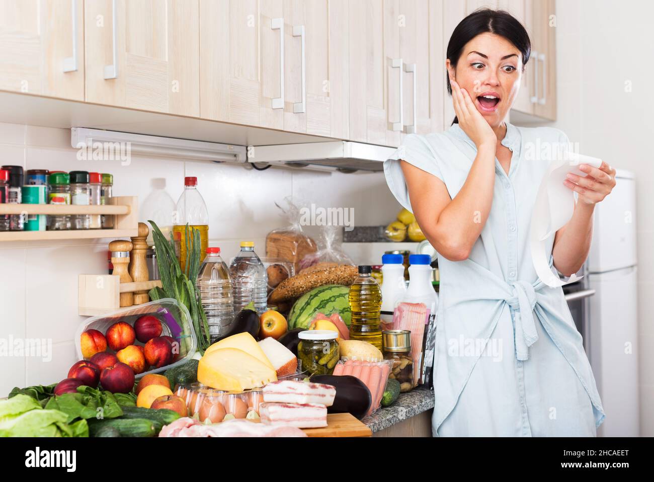 Upset woman checking food Stock Photo - Alamy