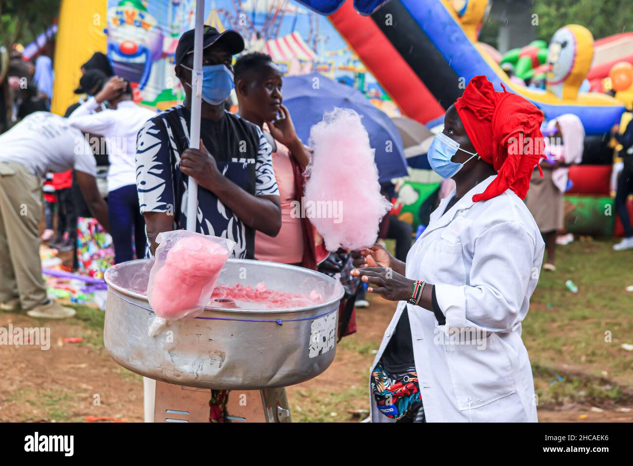 A vendor sells cotton candy to Kenyans at a carnival on Christmas Day ...
