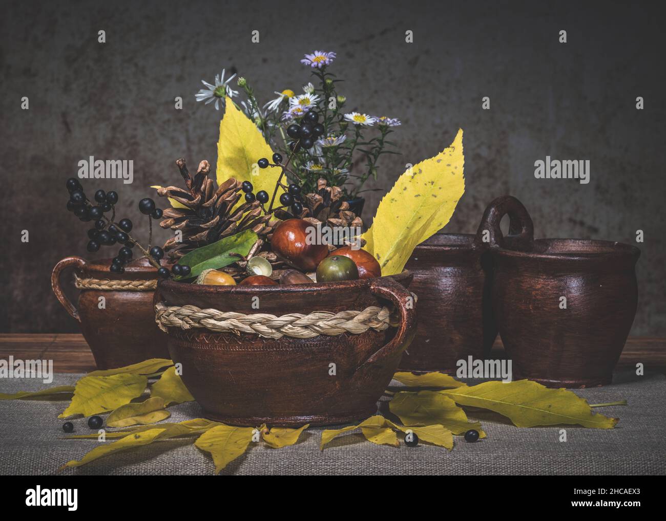 Composition of autumn chestnuts in earthenware Stock Photo - Alamy