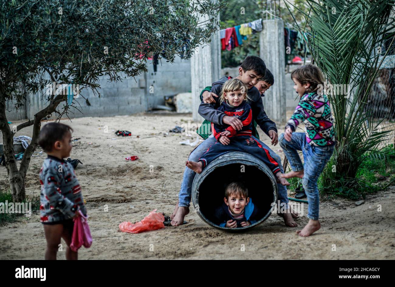 Palestinian children play in front of their house at a poor ...