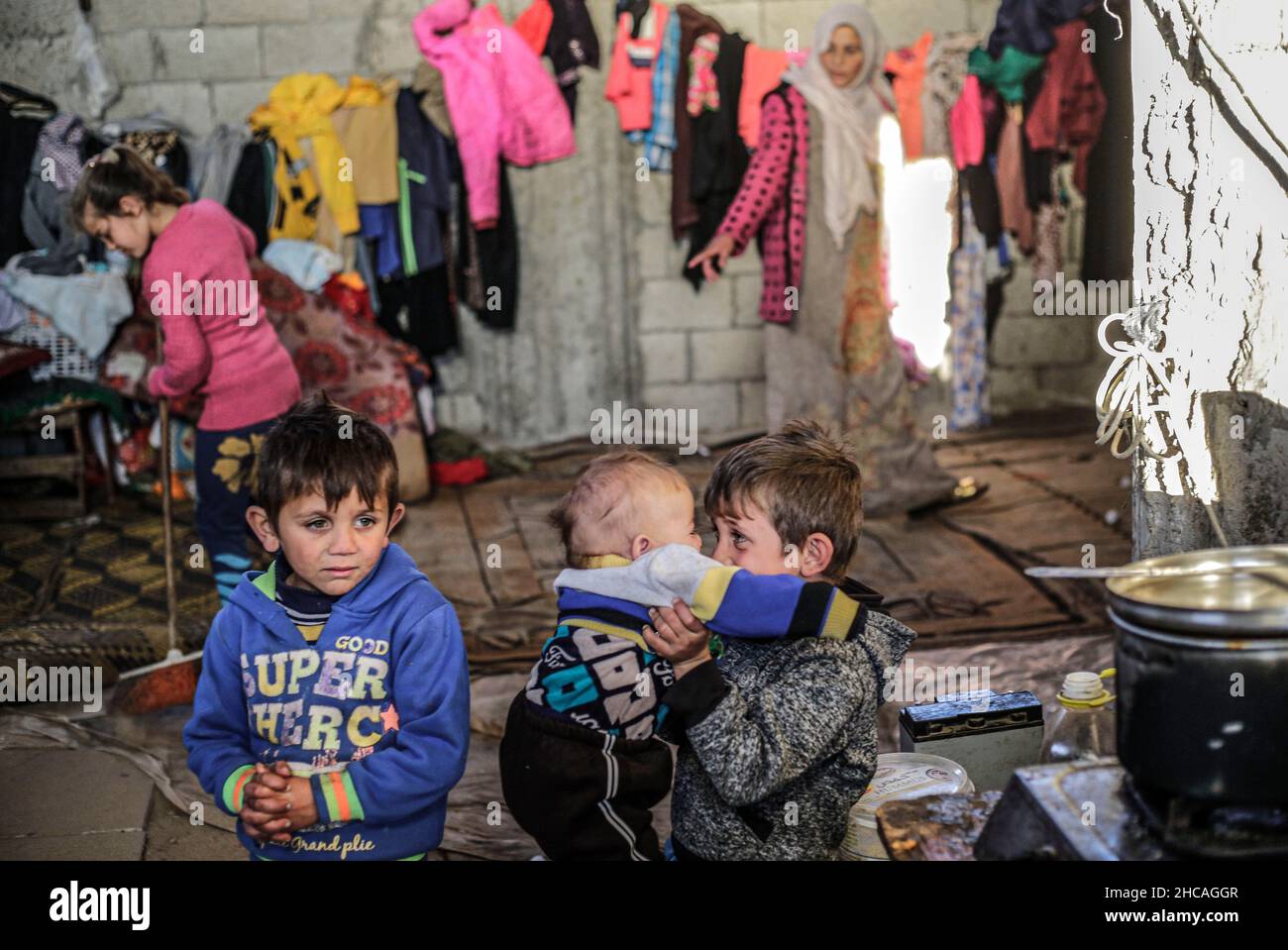 Palestinian children play in front of their house at a poor ...