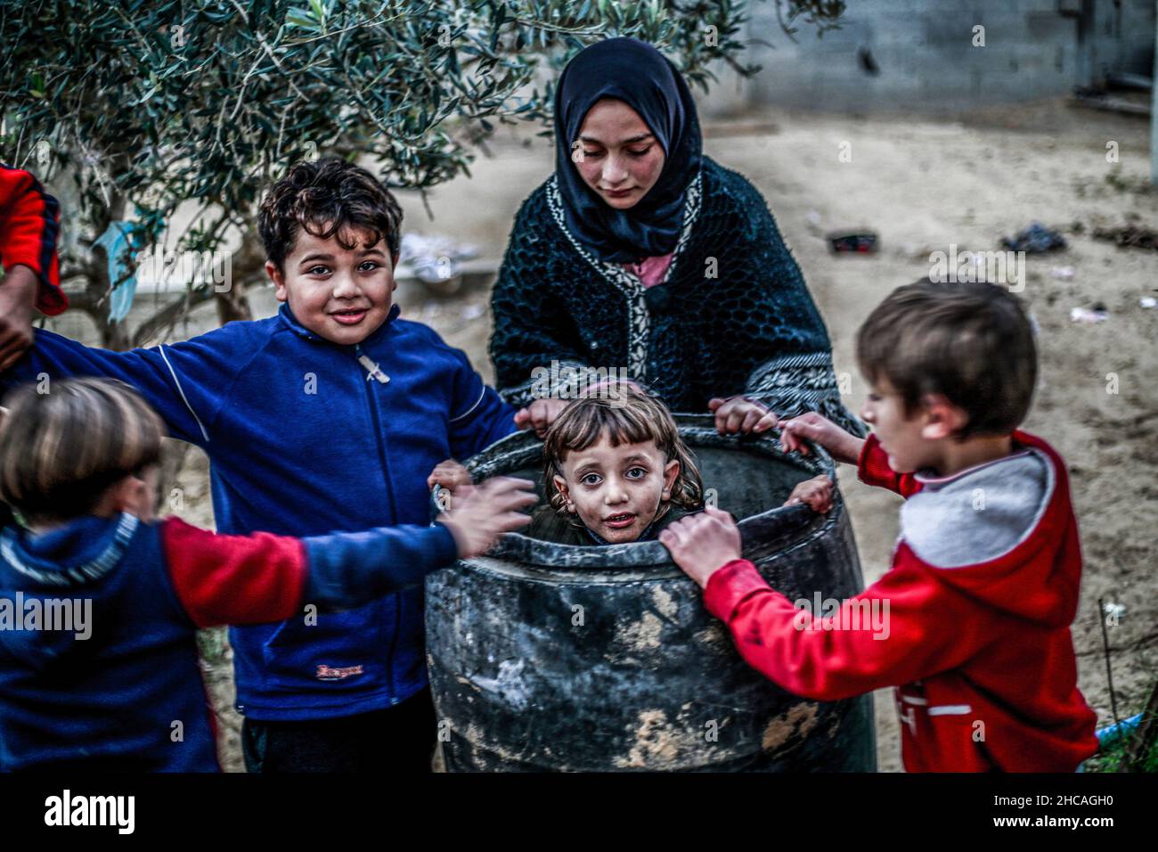 Palestinian children play in front of their house at a poor ...