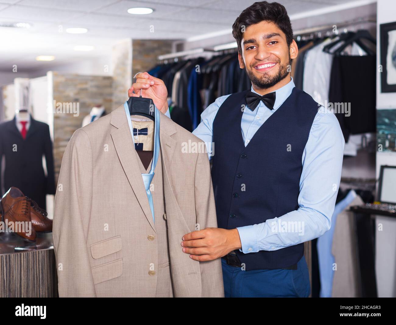 Man demonstrating suit in shop Stock Photo - Alamy