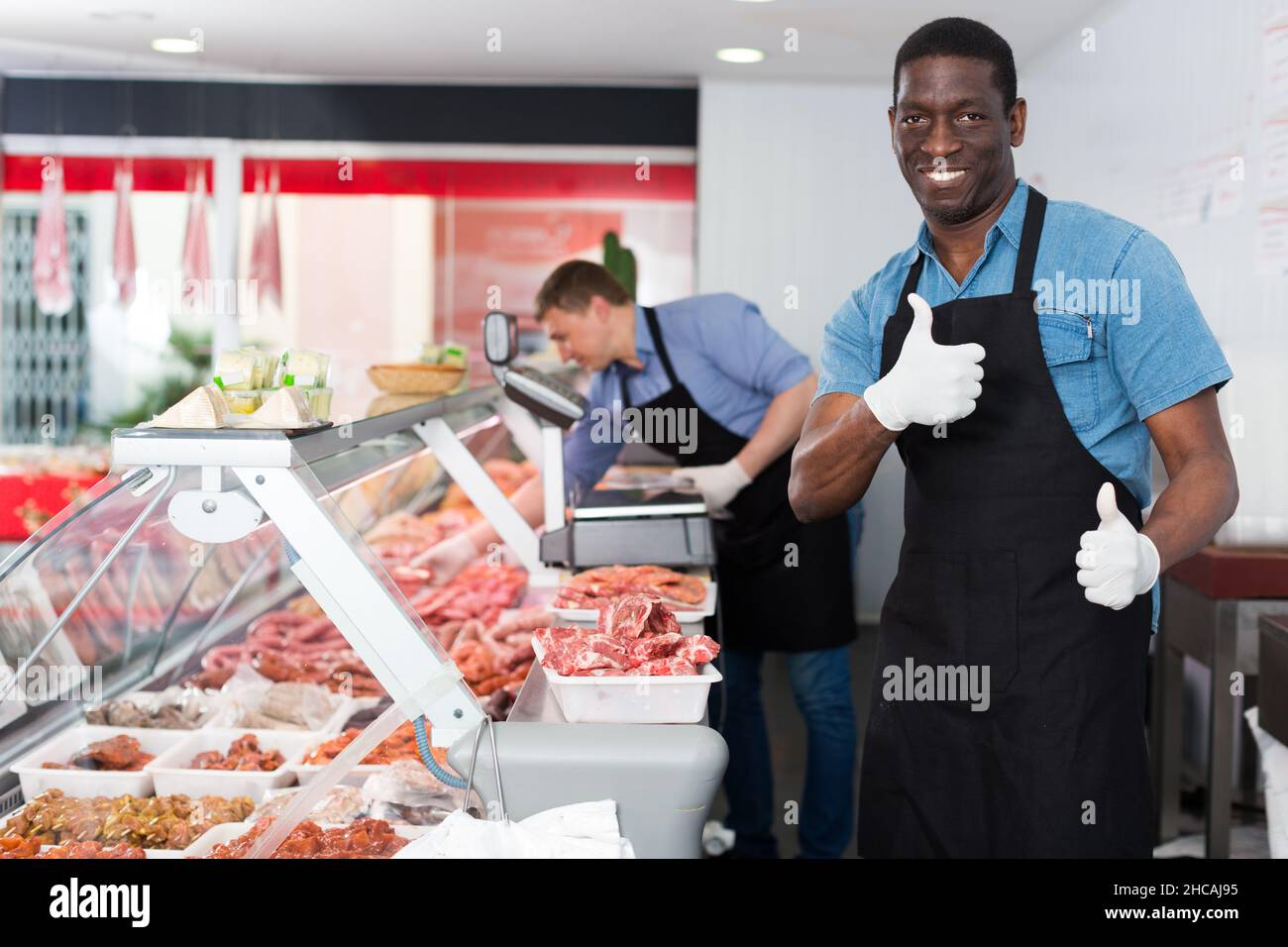 African American butcher giving thumbs up Stock Photo - Alamy