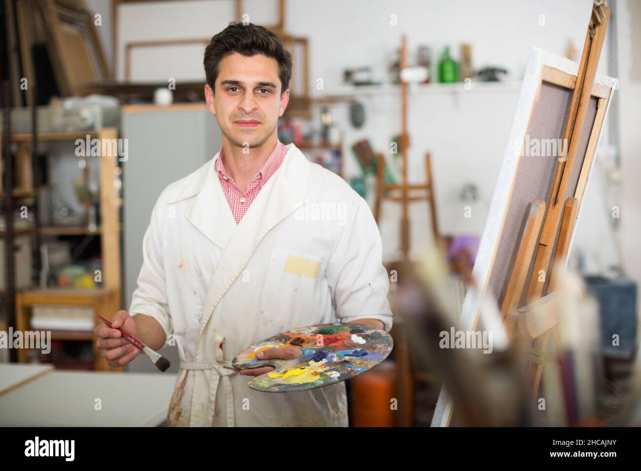 Artist painting on canvas Stock Photo - Alamy