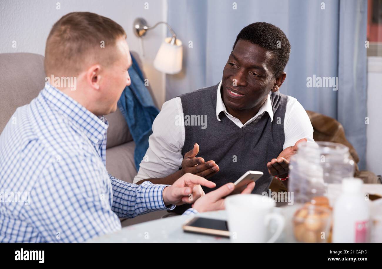 Happy man conversing african hi-res stock photography and images - Alamy