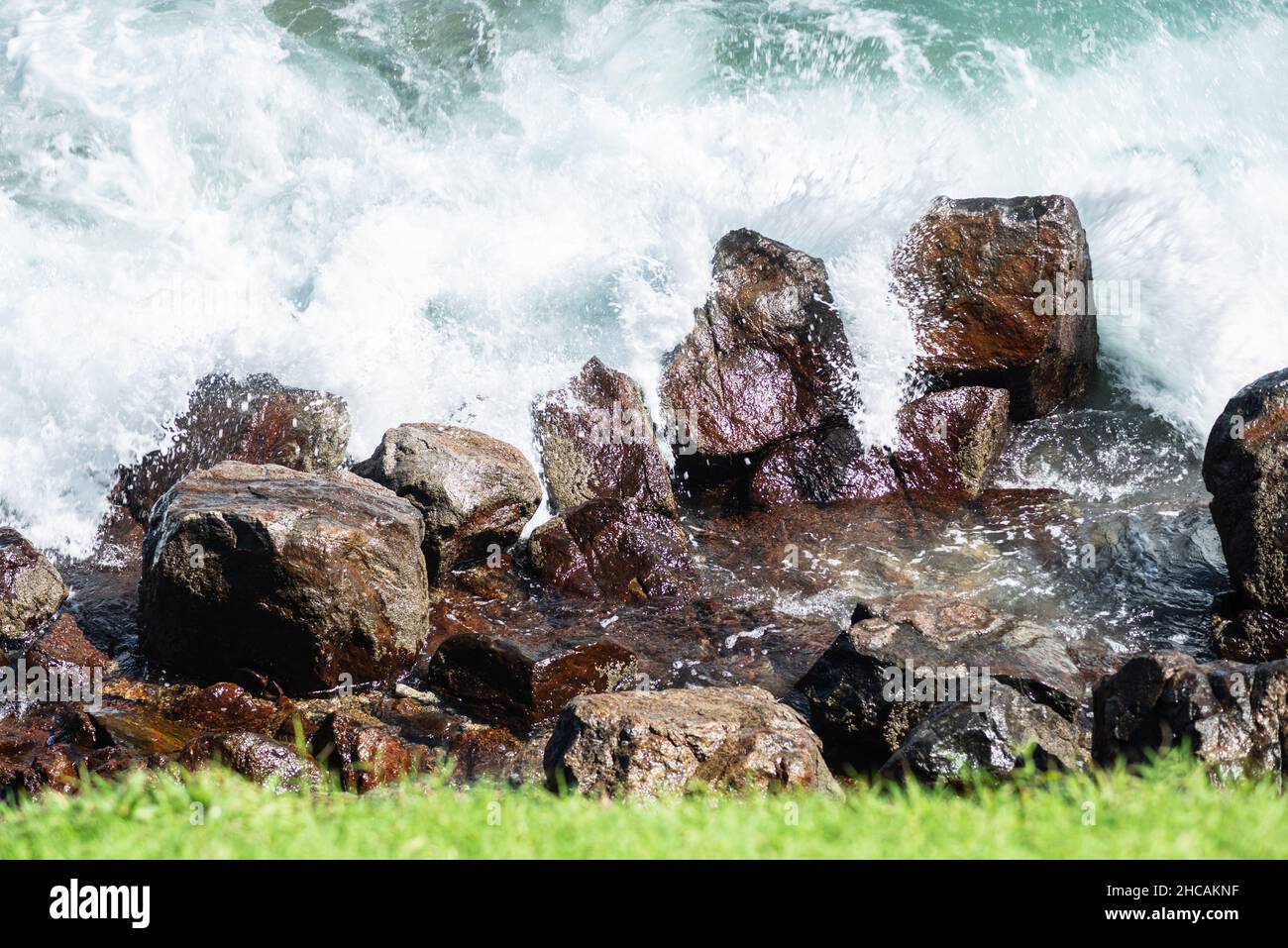 Breaking on rocks by the ocean at the beach hi-res stock photography ...