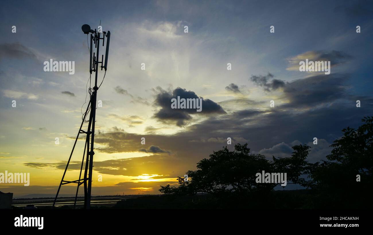 Landscape view of sunrise sky and phone signal transmitter Stock Photo ...