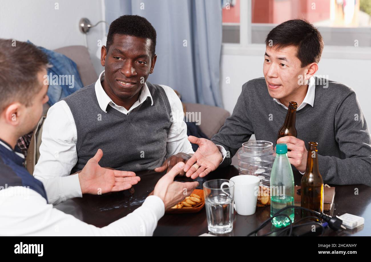 Three friends are talking about life together Stock Photo - Alamy