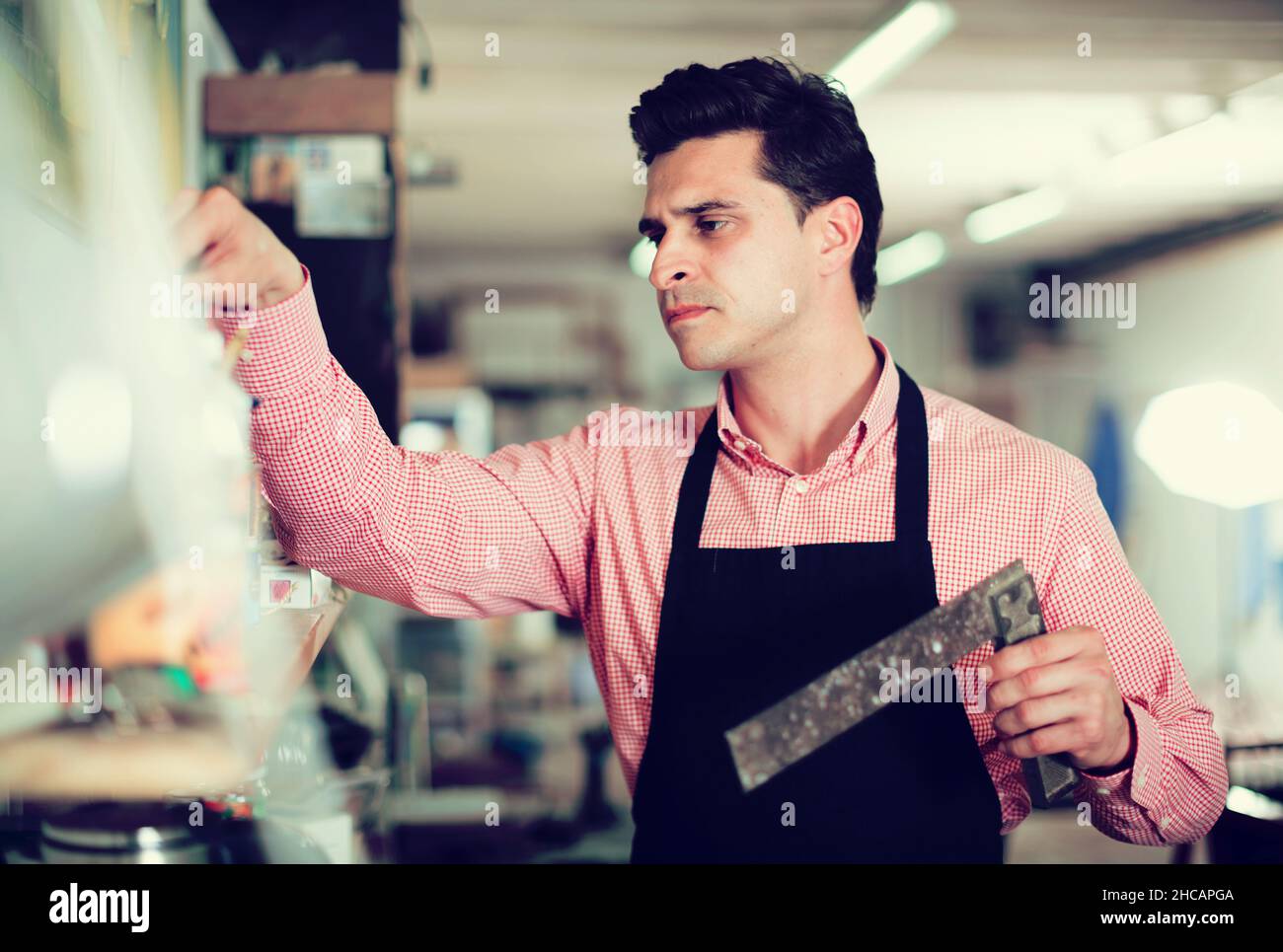 Joiner looking for necessary tools Stock Photo - Alamy