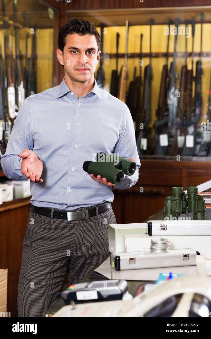 Salesman offering accessories for hunt Stock Photo - Alamy