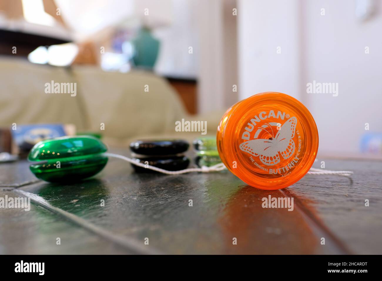 Assorted Duncan yoyos on a living room table: orange Butterfly yo-yo ...