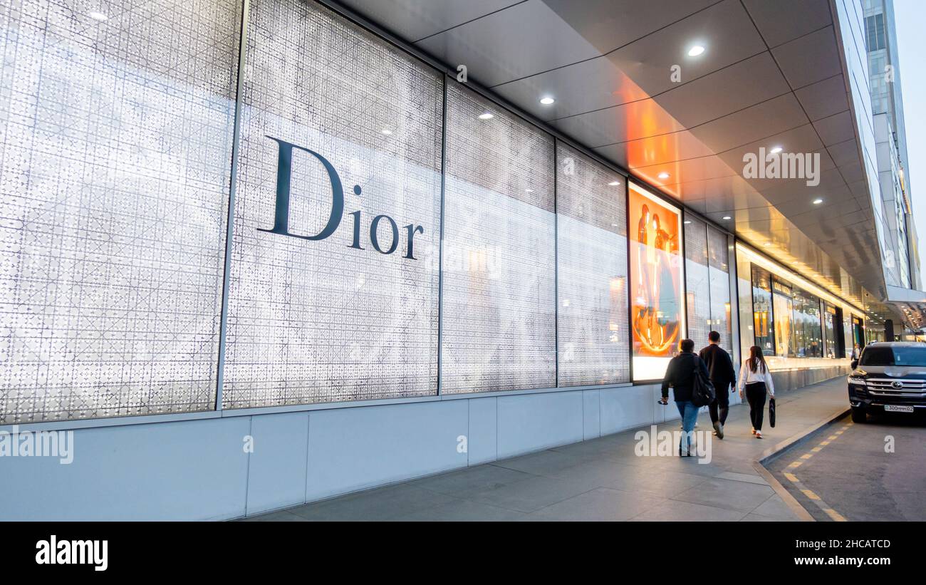 People pass by the big prada advertisement on the Esentai mall wall ...