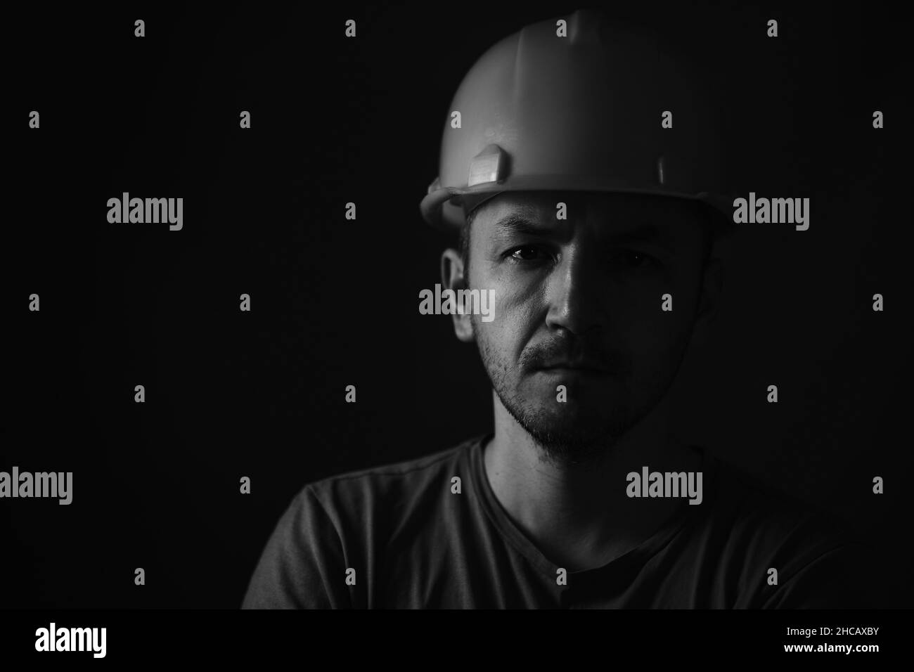 Dirty face of coal miner on a black background. Head of tired mine ...