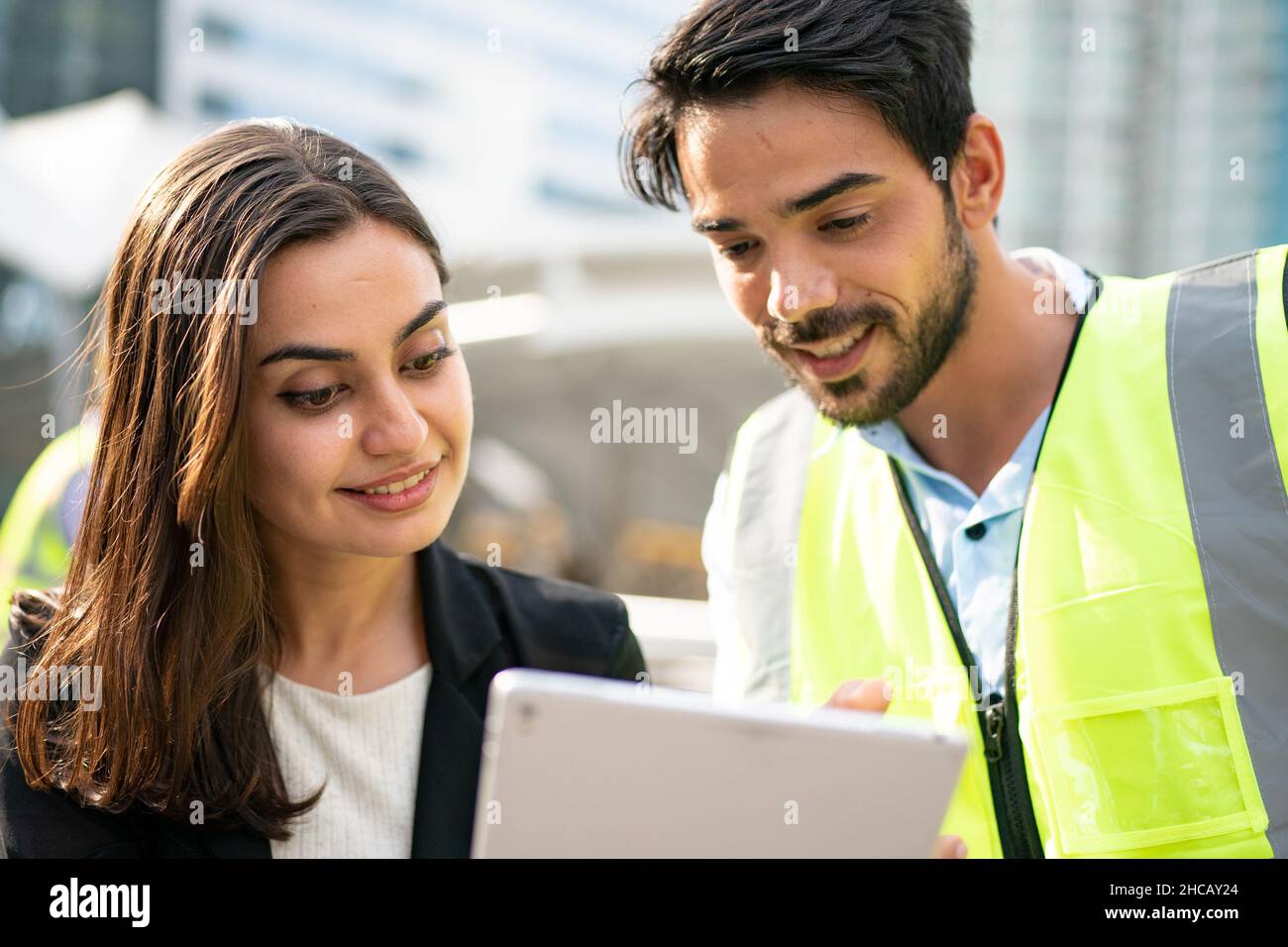 portrait of an industrial man and woman engineer with tablet in a ...