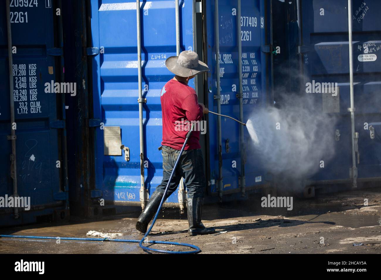 worker is cleaning container water spay gun Stock Photo - Alamy
