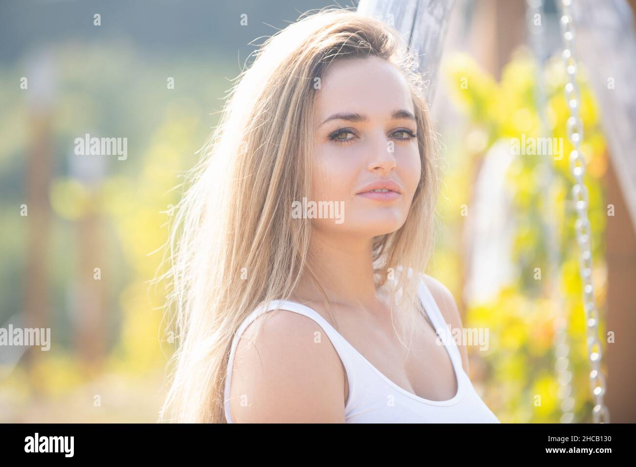 Portrait of a young woman, close up face of beautiful woman outdoor. Cheerful female model ...