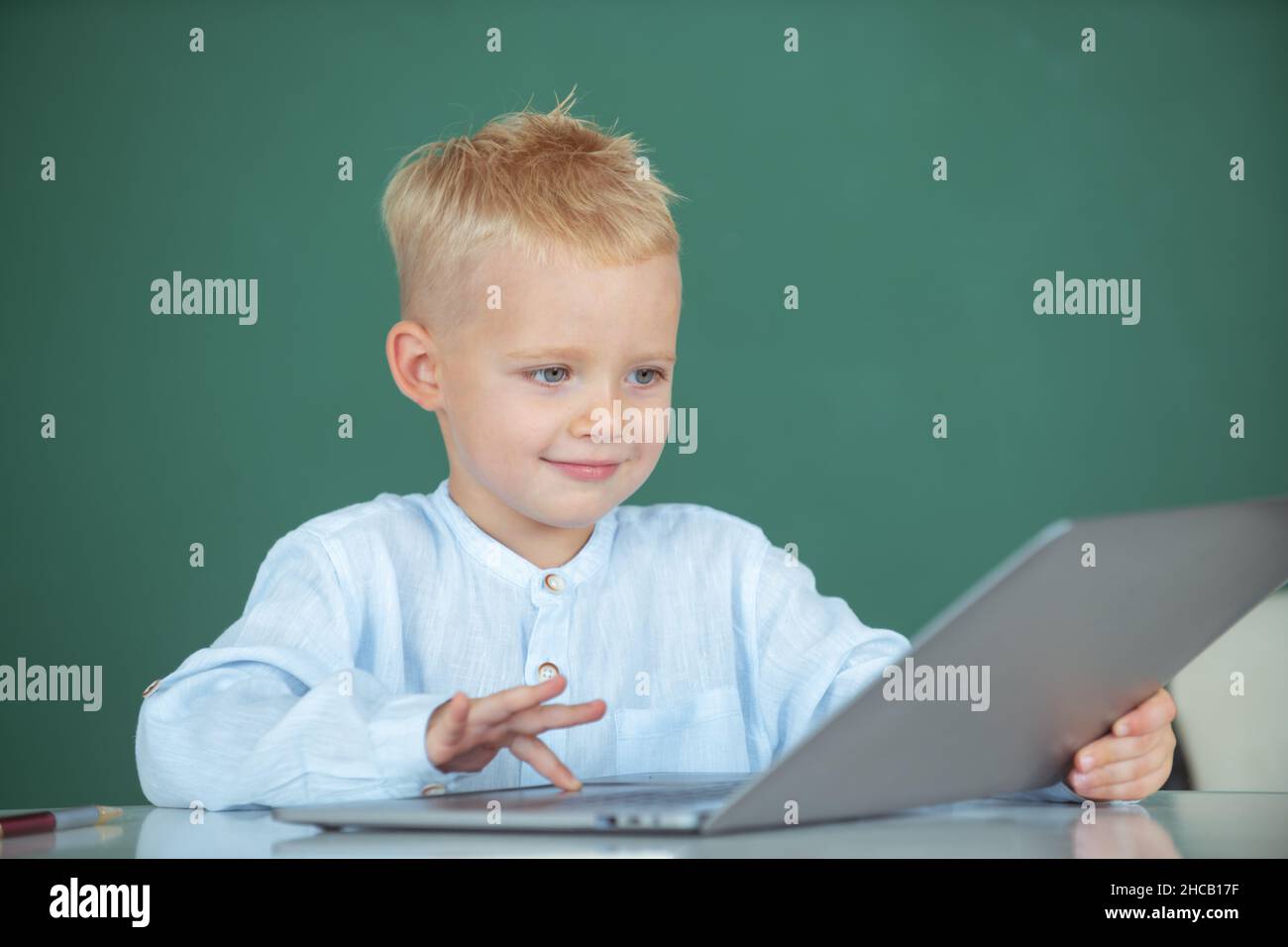 School boy studying math during online lesson in classroom, online ...